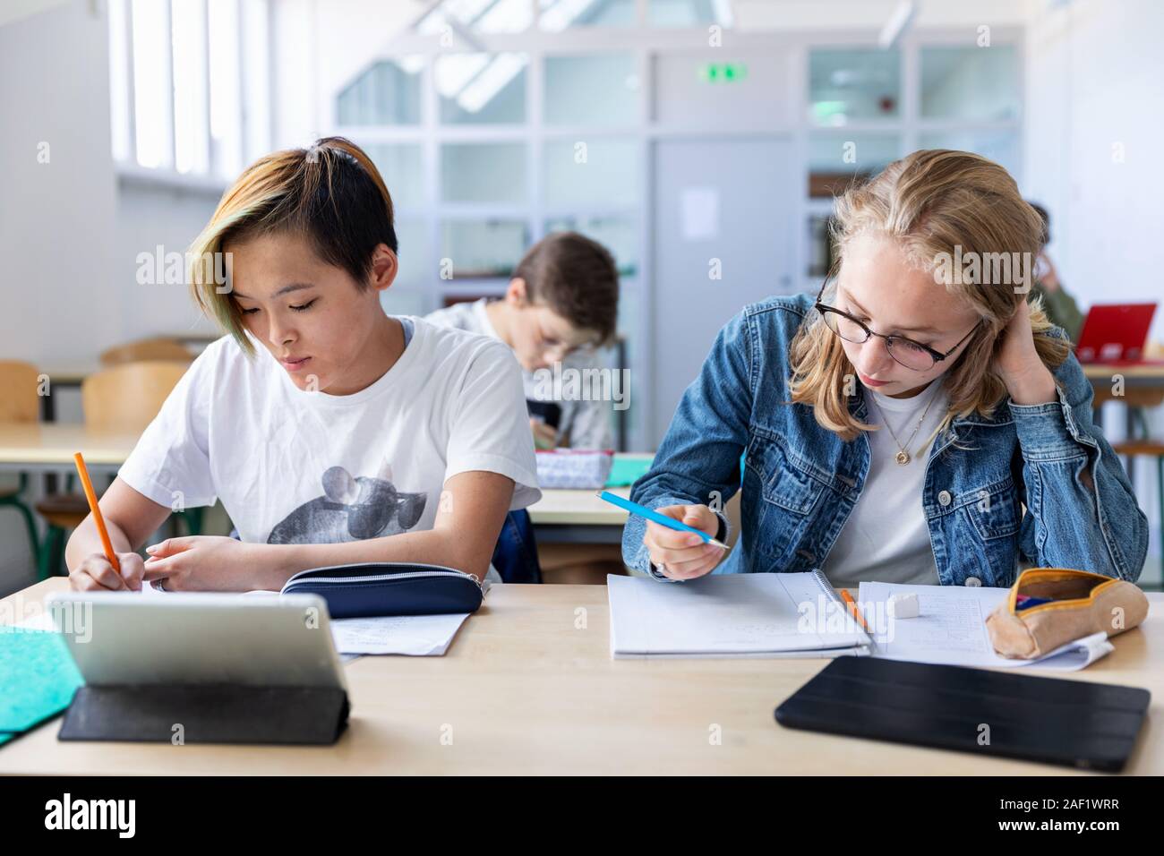 Teenage girls in classroom Stock Photo - Alamy