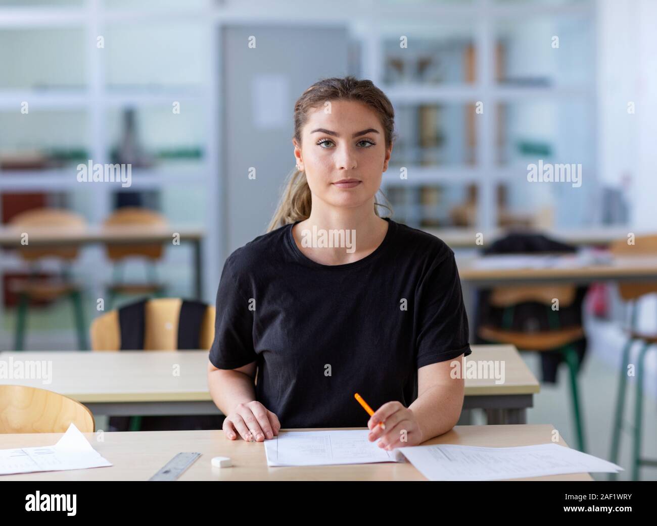 Teenage girl sitting in classroom Stock Photo - Alamy