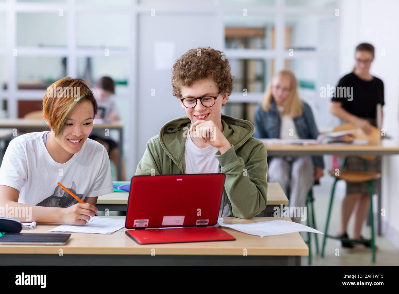 Teenagers in classroom Stock Photo - Alamy