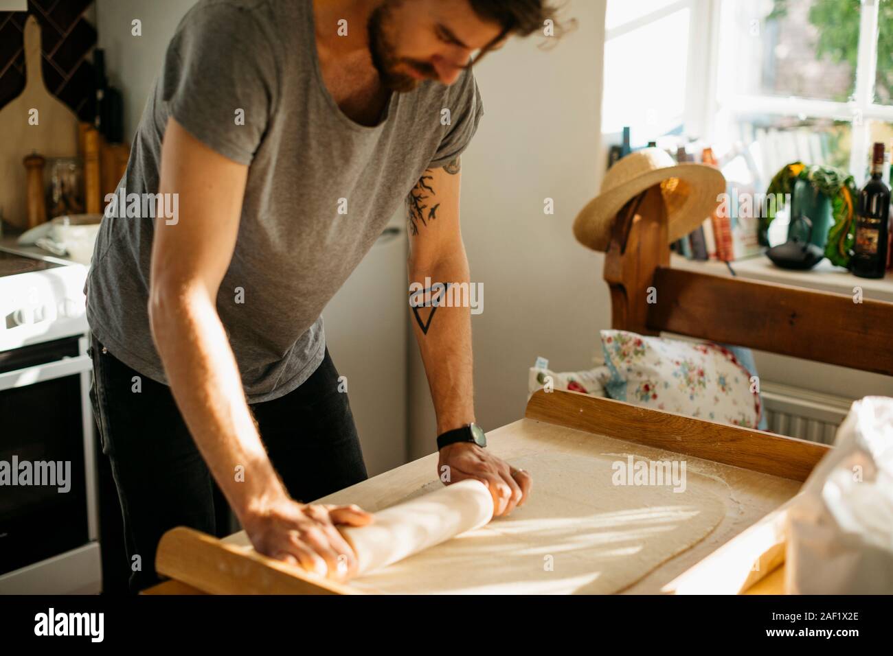 Man rolling dough Stock Photo - Alamy