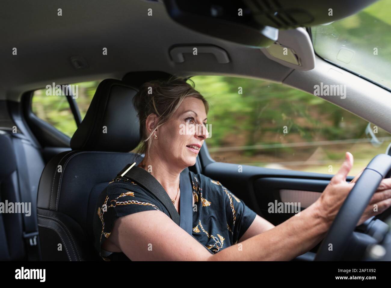 Woman driving car Stock Photo - Alamy