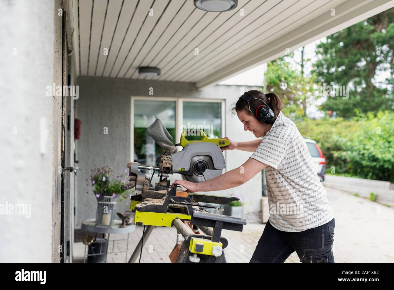 Woman using bench saw Stock Photo - Alamy