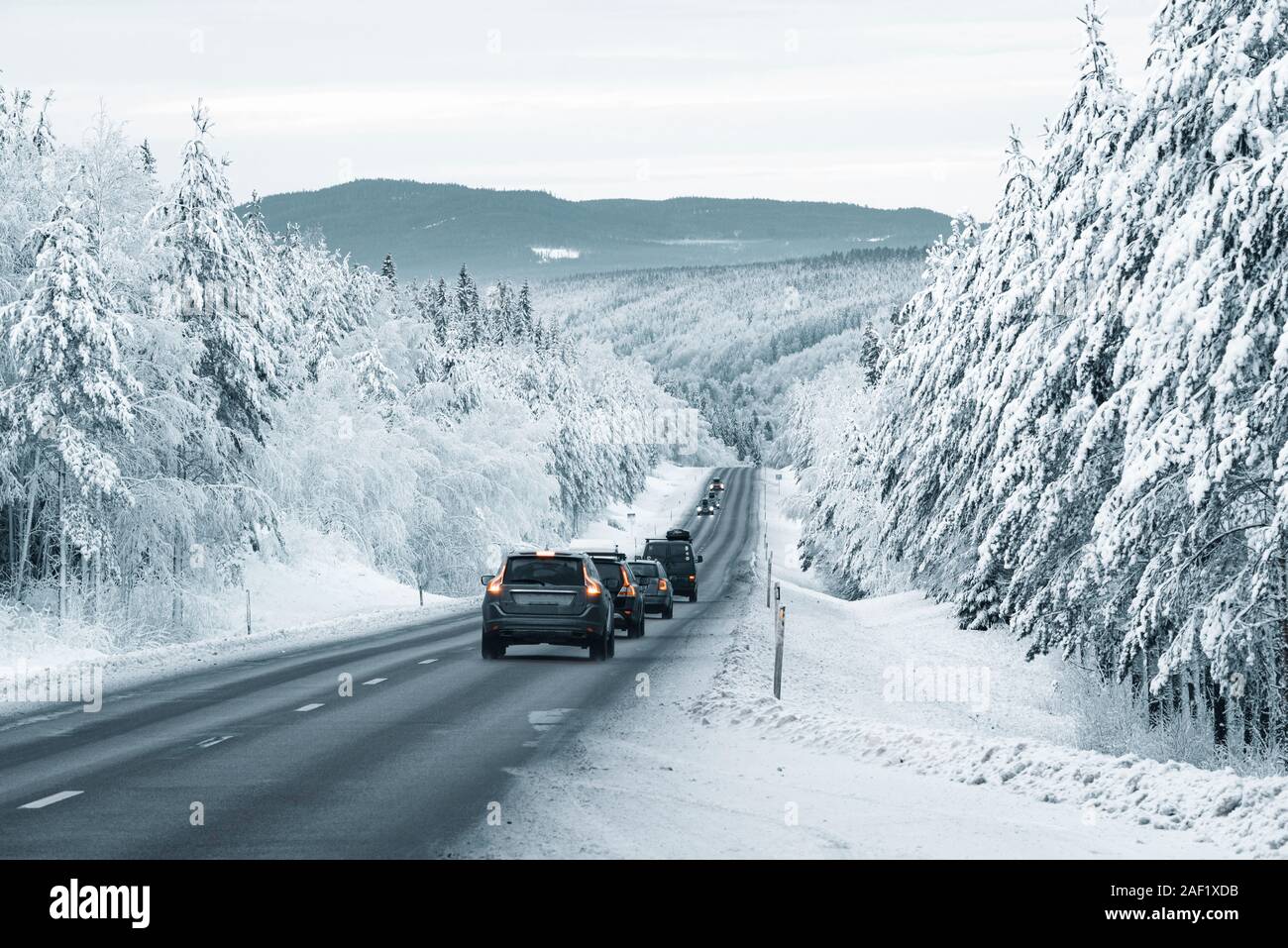 Cars on winter road Stock Photo - Alamy