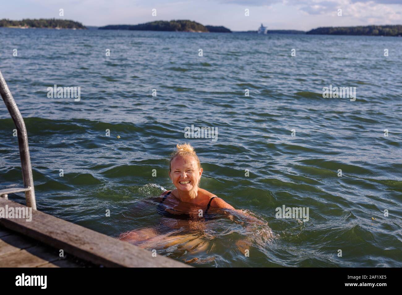 Woman swimming in sea Stock Photo - Alamy