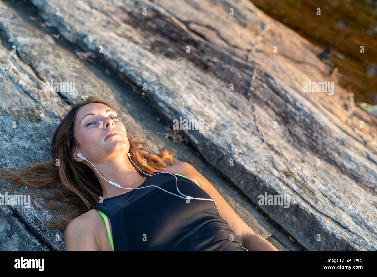 Woman lying on rocks hi-res stock photography and images - Alamy