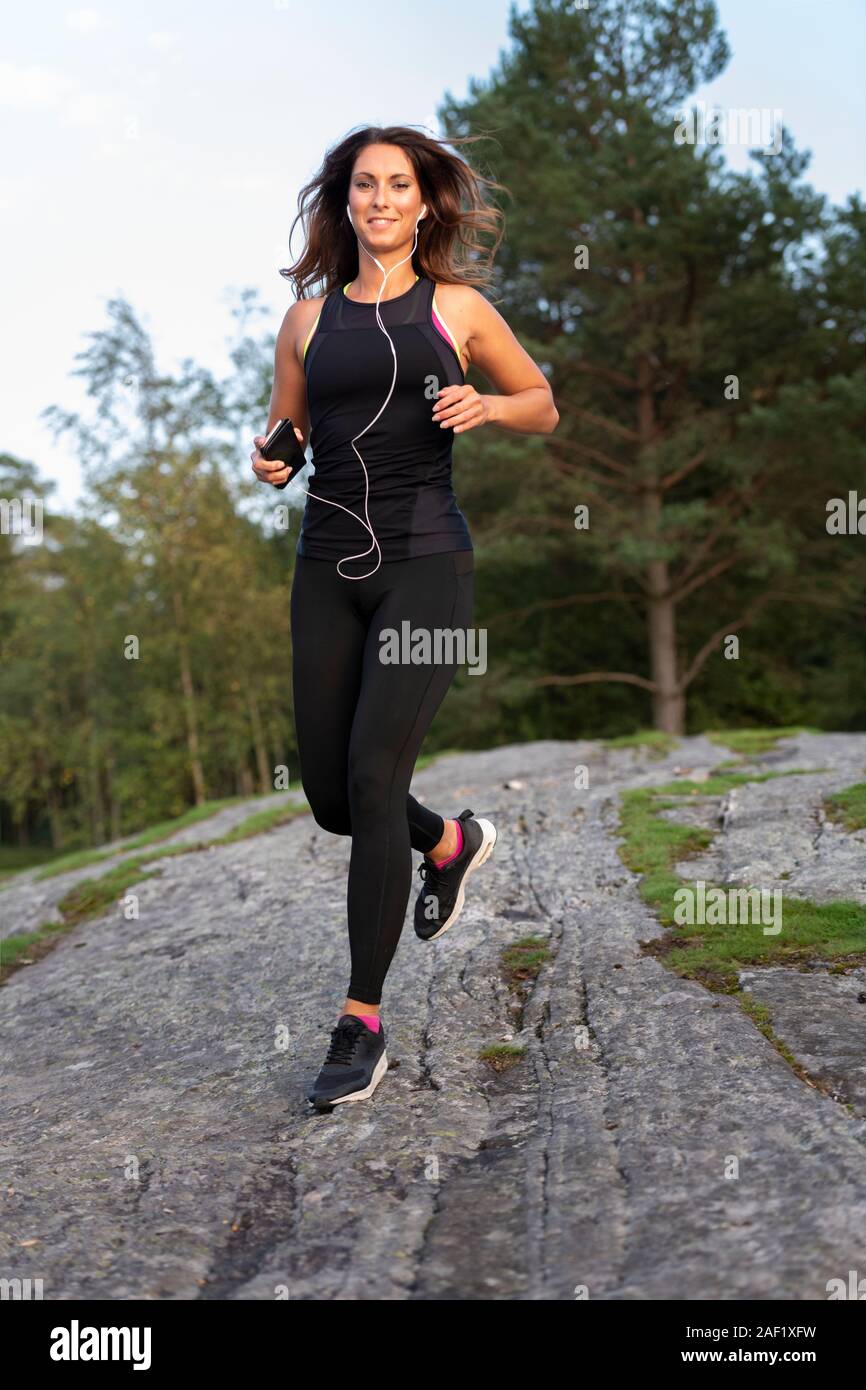 Woman jogging outside Stock Photo - Alamy
