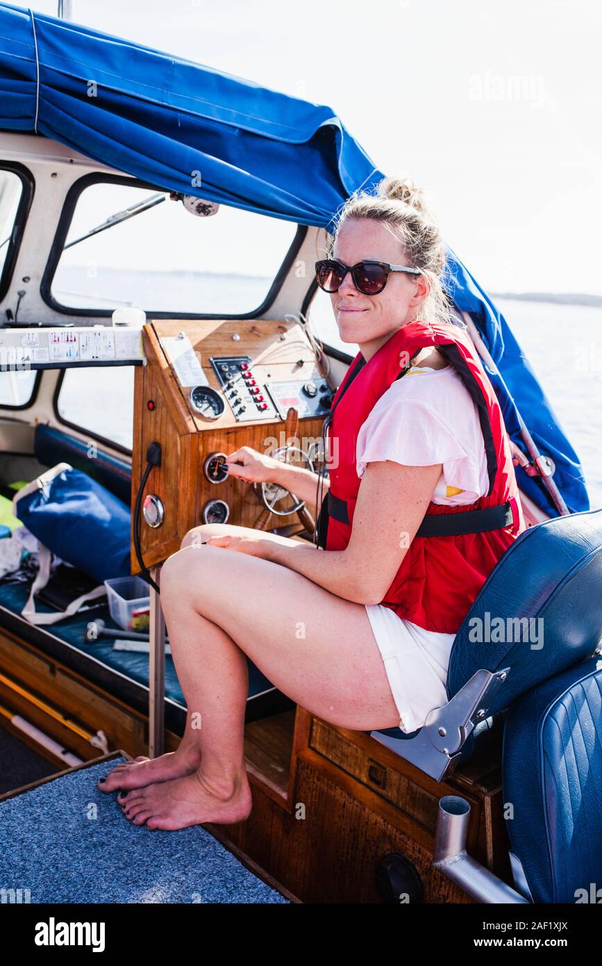 Smiling woman sitting on boat hi-res stock photography and images - Alamy