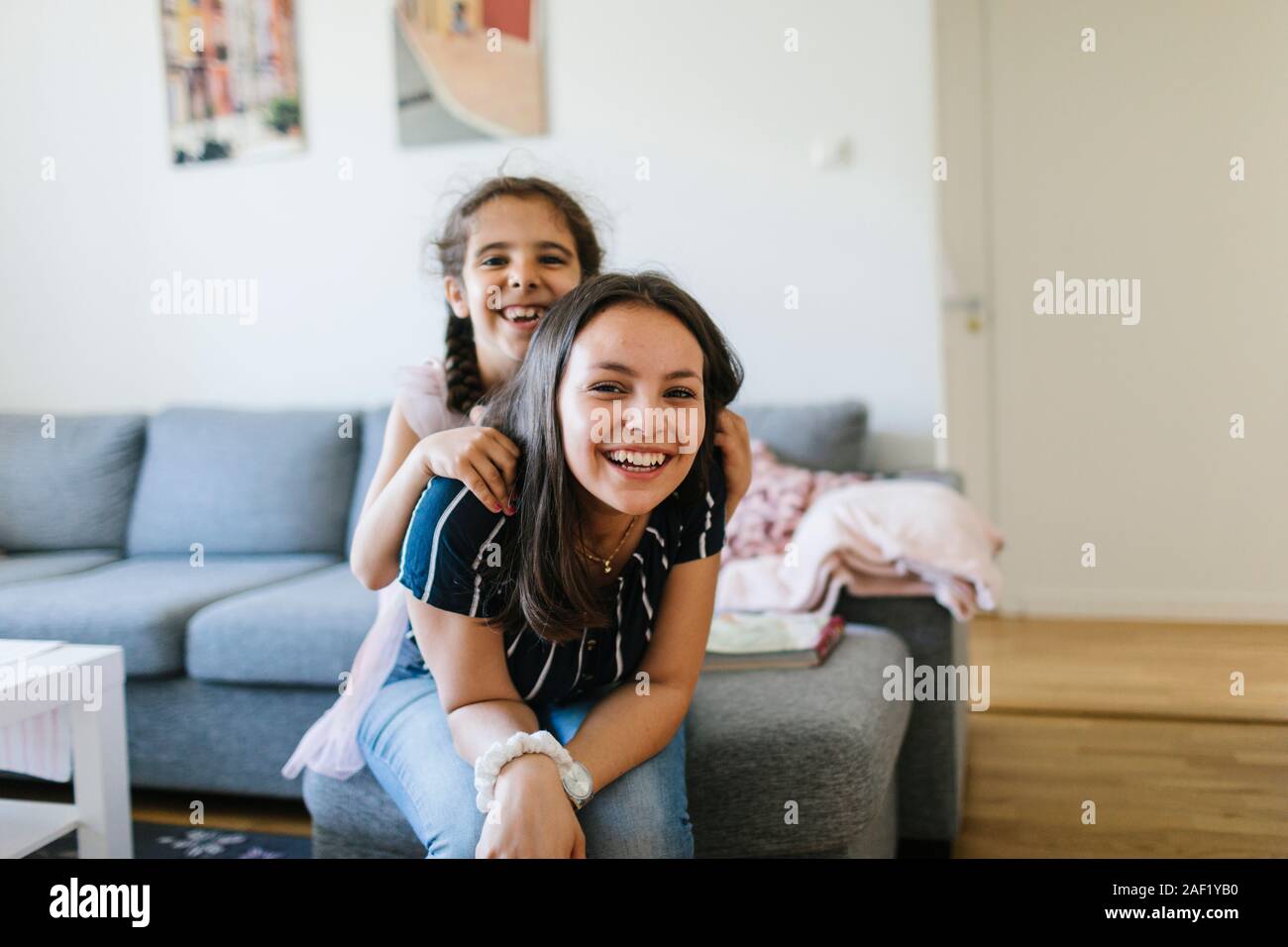 Smiling sisters together Stock Photo - Alamy