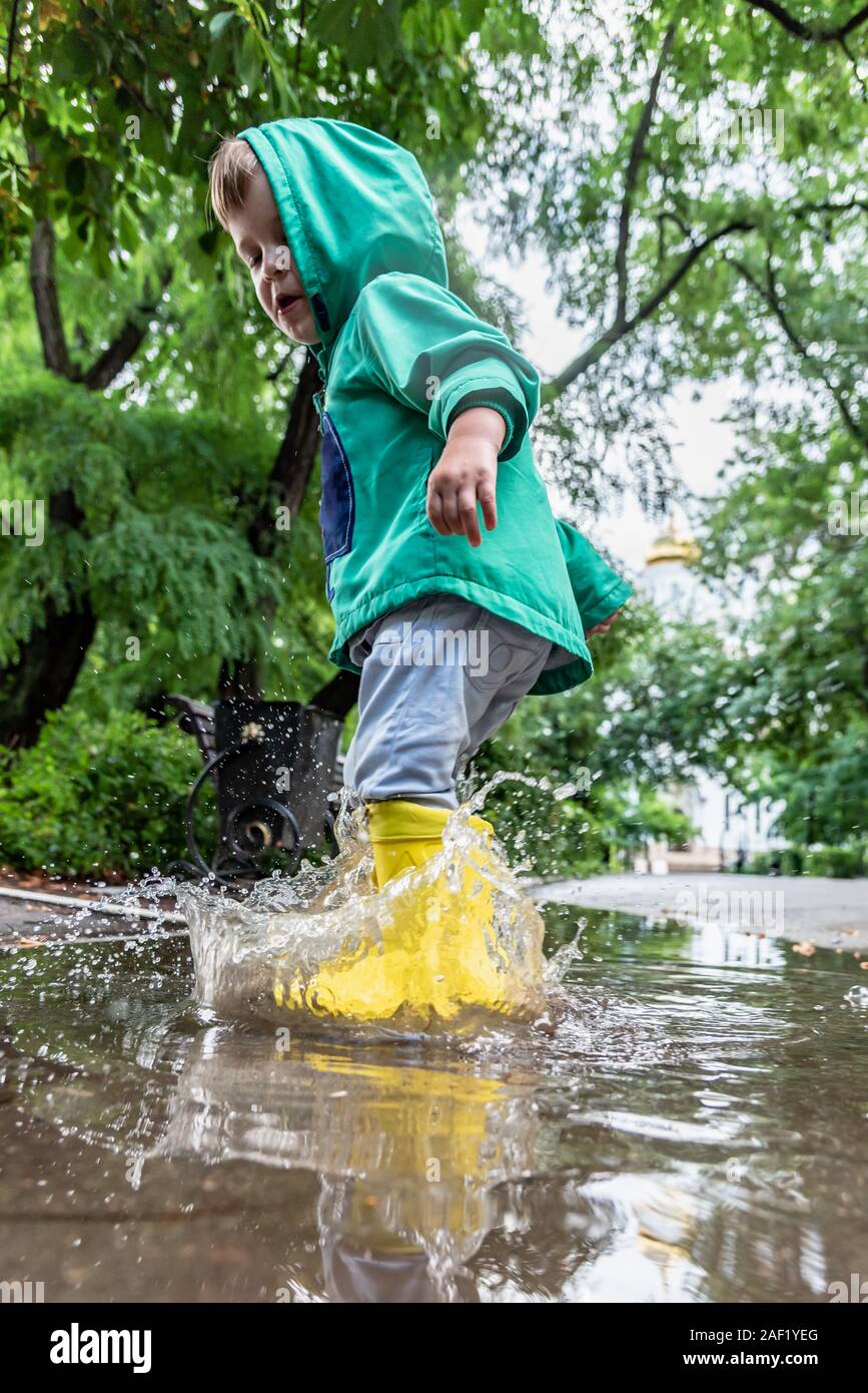 Child Jumping In Puddle Spring Boots High Resolution Stock Photography ...