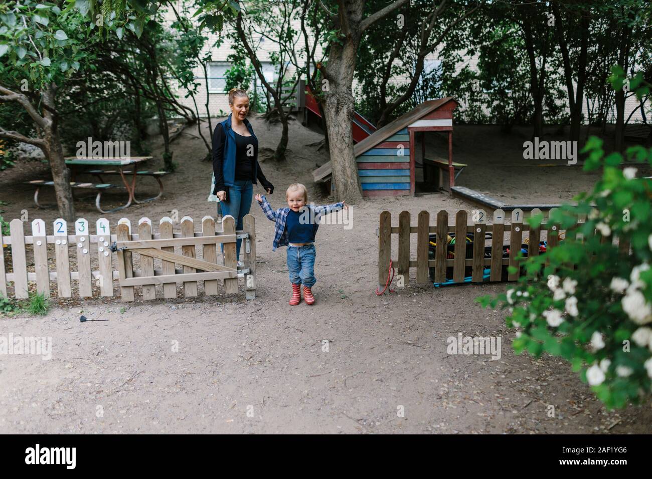 Woman on playground fence hi-res stock photography and images - Alamy
