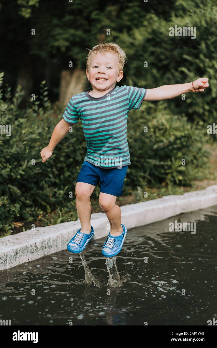 Kid Jumping In A Mud Puddle High Resolution Stock Photography and ...