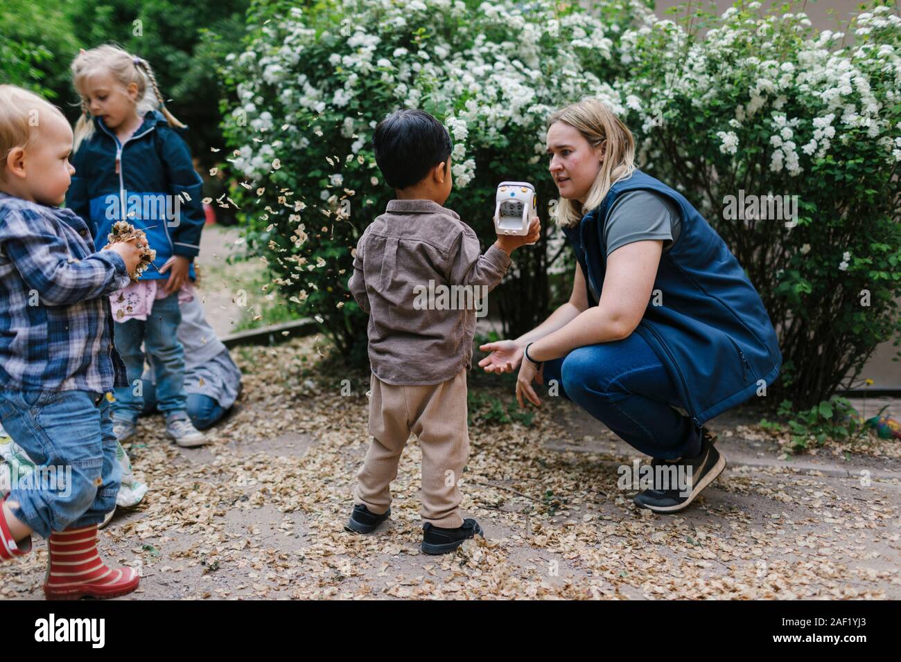 Teacher with children outside Stock Photo - Alamy