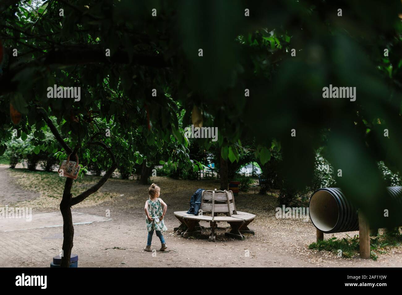 Girl standing near bench Stock Photo - Alamy