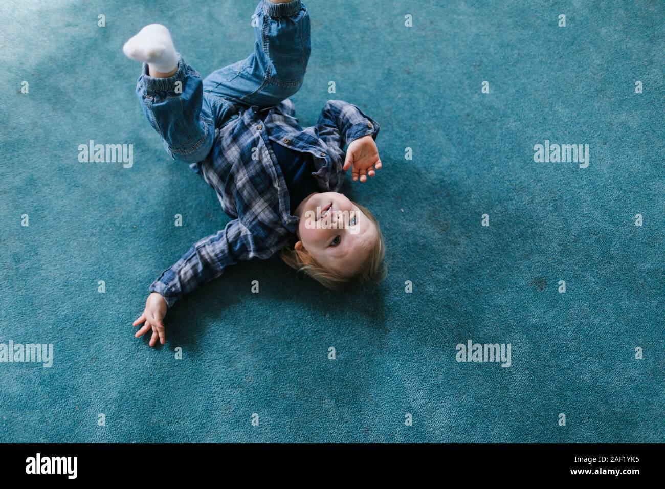 Boy having fun on carpet Stock Photo - Alamy