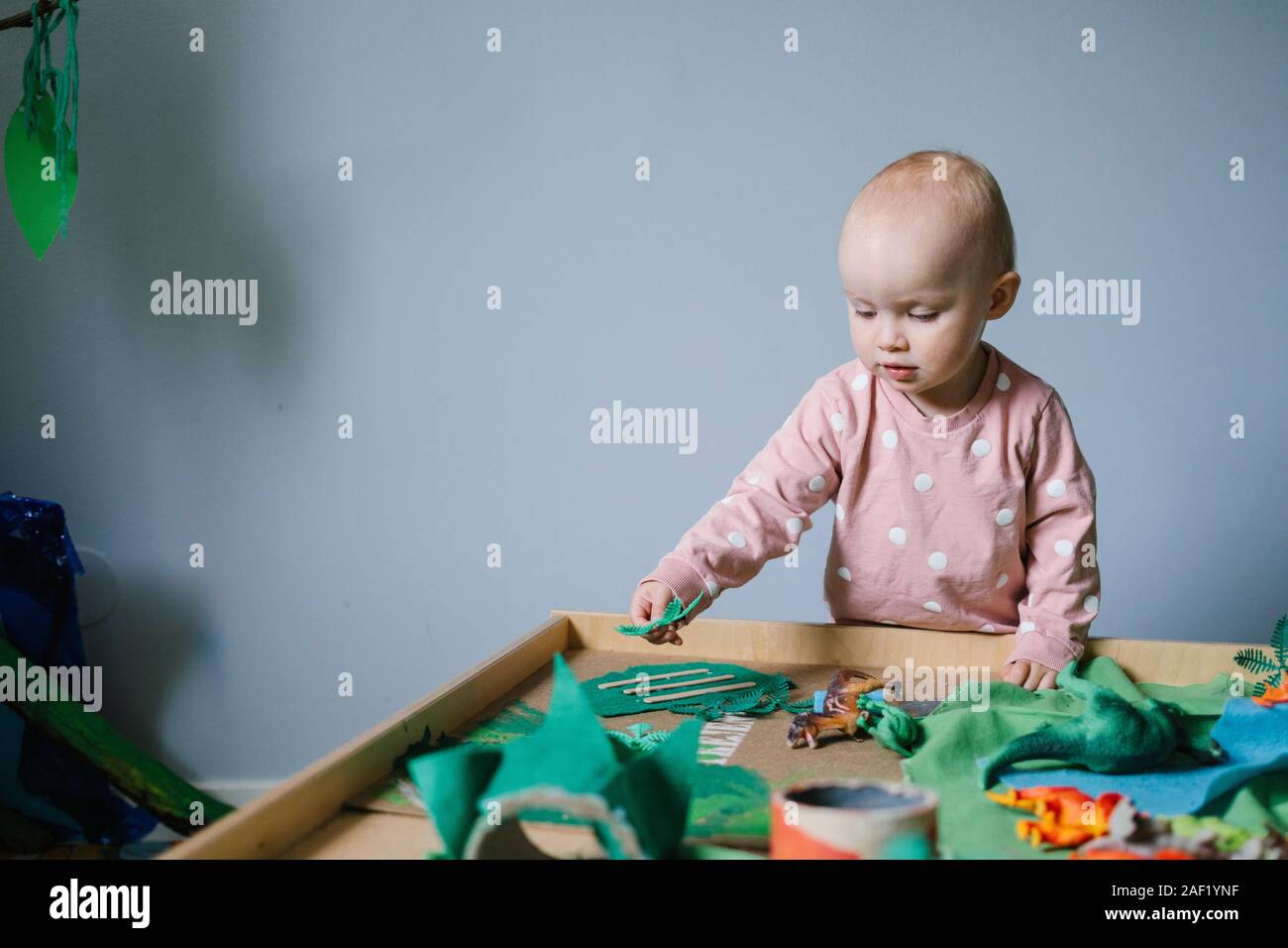 Toddler girl playing Stock Photo - Alamy
