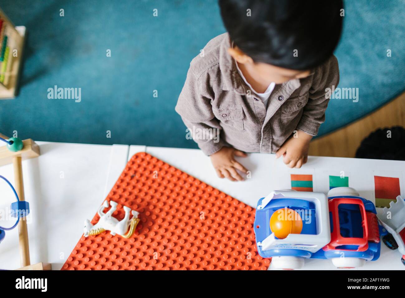 Boy looking at toys Stock Photo - Alamy