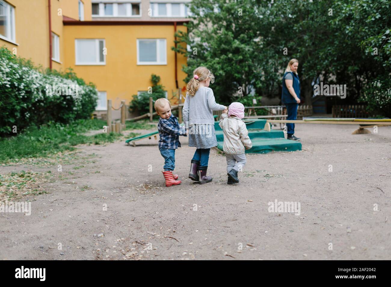 Walking to school holding hands hi-res stock photography and images - Alamy