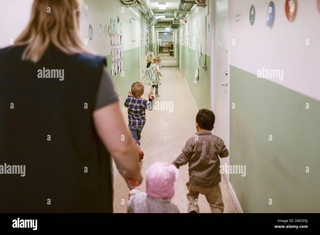 Children running through corridor Stock Photo - Alamy