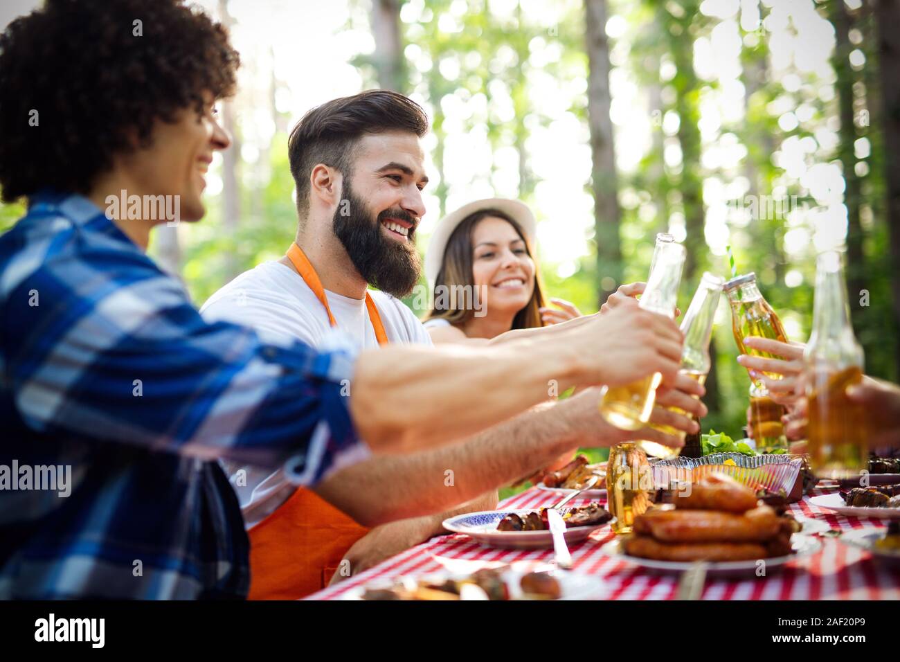 Group of happy young friends having barbecue party, outdoors Stock ...