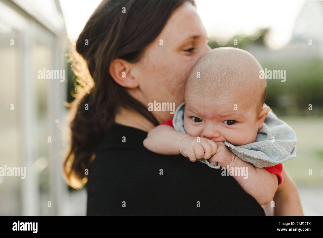 Mother carrying baby daughter Stock Photo - Alamy