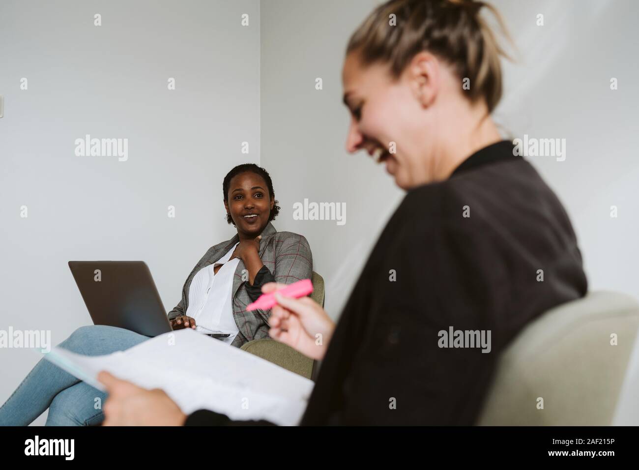 Smiling women talking Stock Photo - Alamy