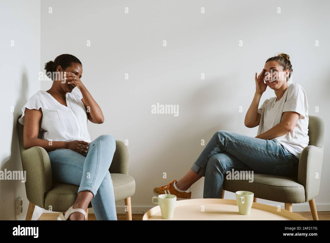 Smiling women talking together Stock Photo - Alamy