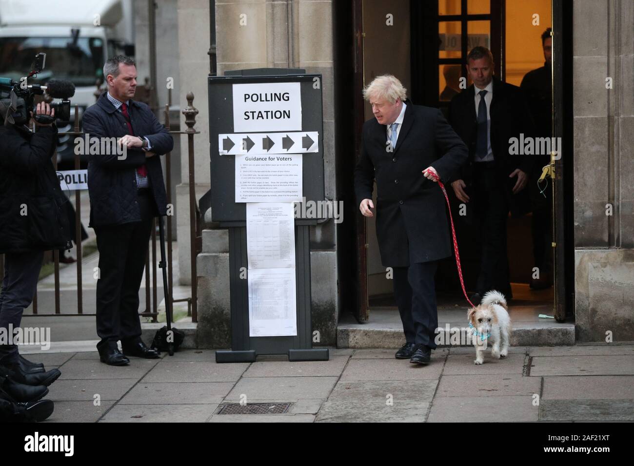 Prime Minister Boris Johnson holds his dog, Dilyn, after casting his ...