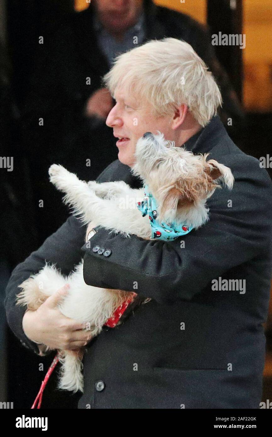 Prime Minister Boris Johnson holds his dog, Dilyn, after casting his ...