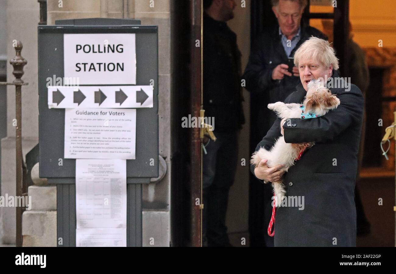 Prime Minister Boris Johnson holds his dog, Dilyn, after casting his ...