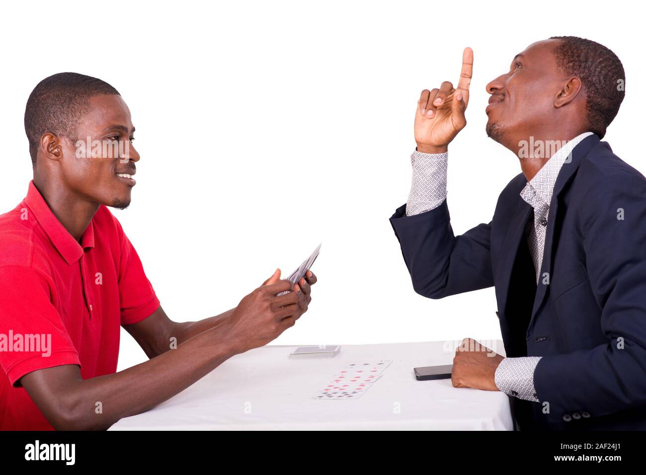 Young men playing cards at the game table, young people having funny ...