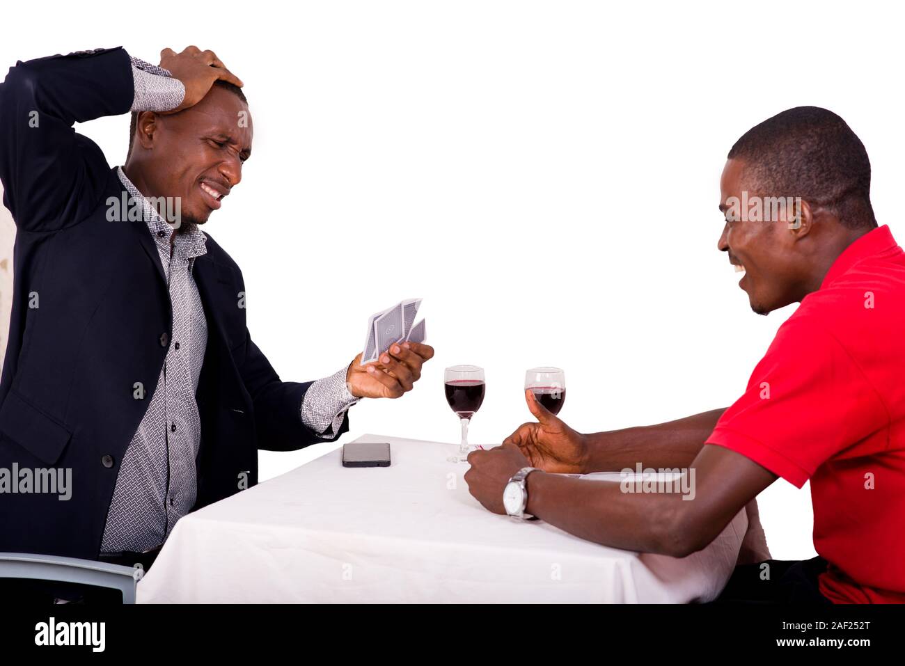 poker game between two men around a table and man in costume ...