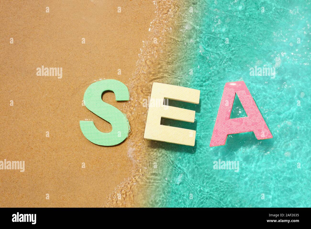 Sea sign floating in water near beach sand edge Stock Photo - Alamy