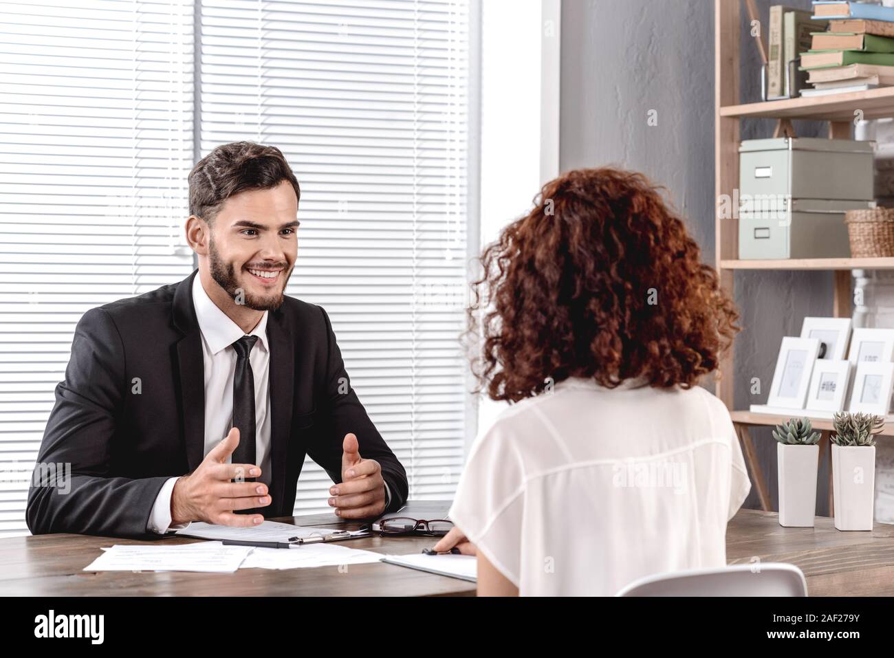 Job Interview. Employer talking with candidate smiling cheerful sitting ...