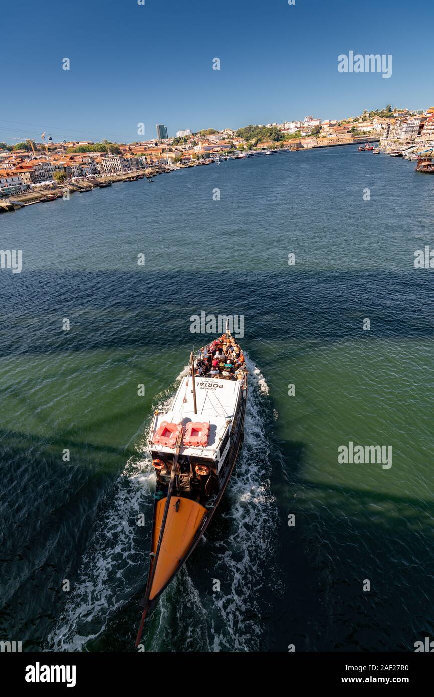 A cruise boat on the Douro river seen from above with tourists Porto ...