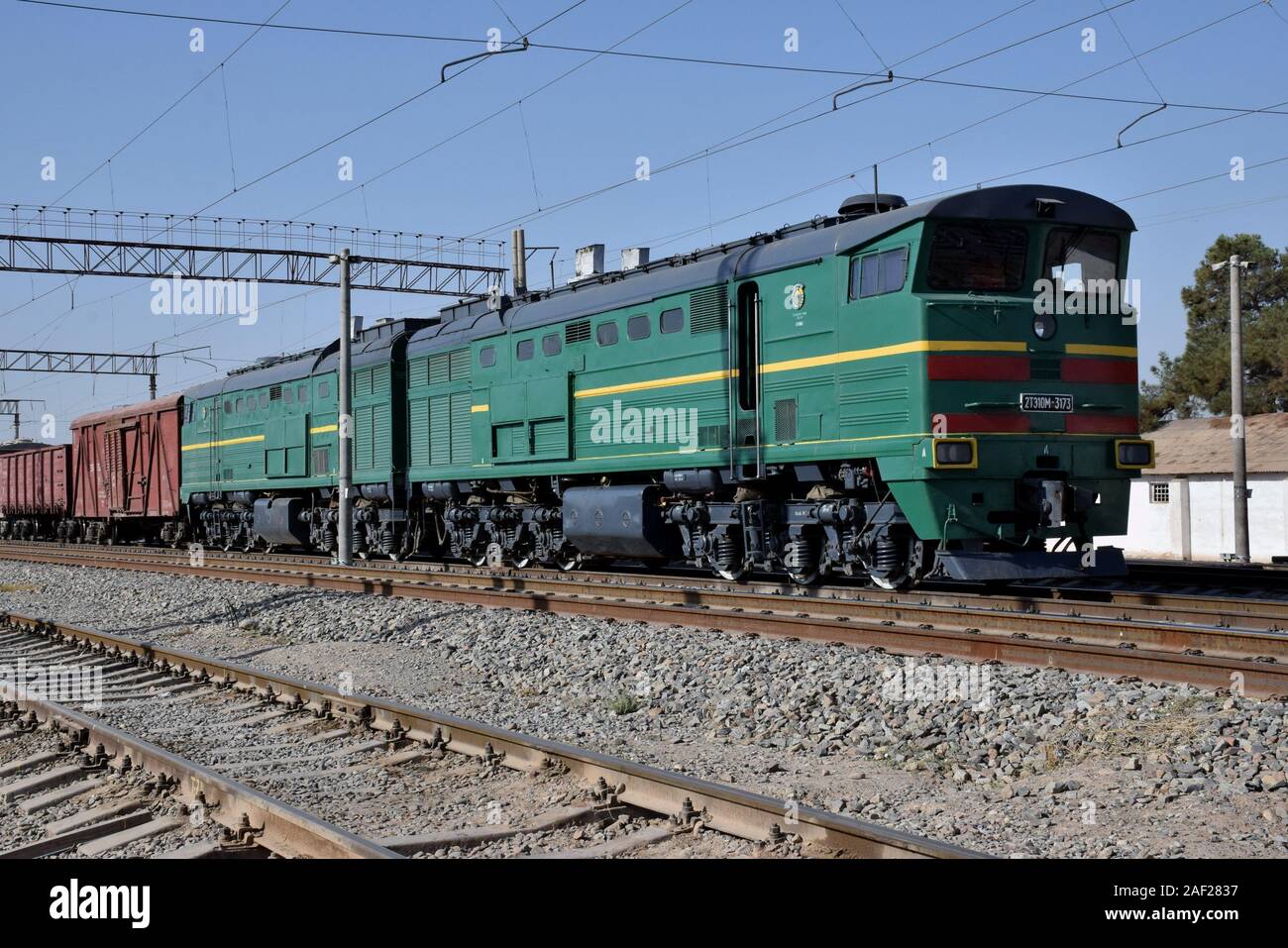 Diesel locomotive 2TE10M-3173 with freight train in the station on 13. ...