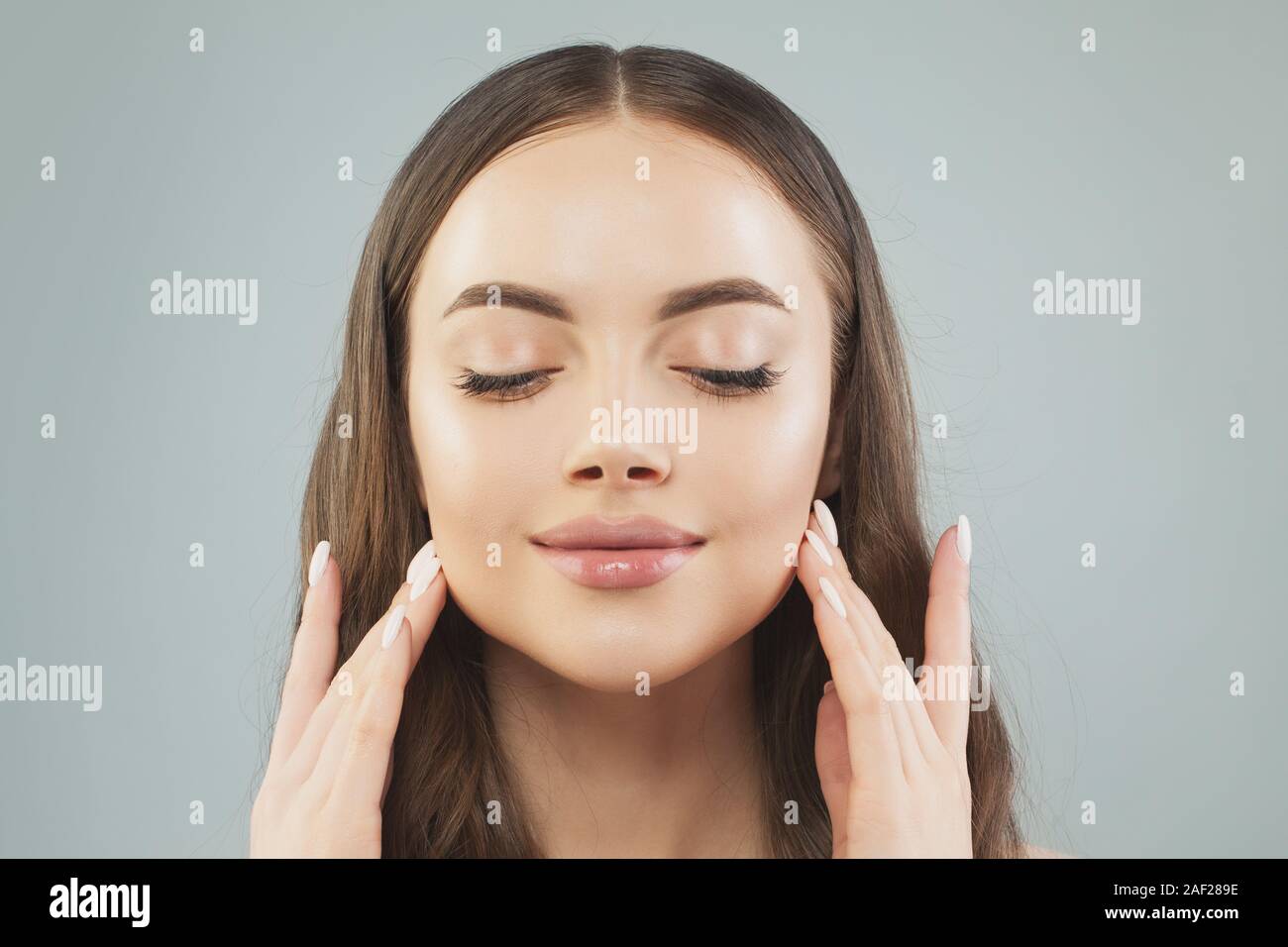 Beautiful woman face closeup. Eyes closed. Facial treatment, moisturizing, relaxation and skin ...
