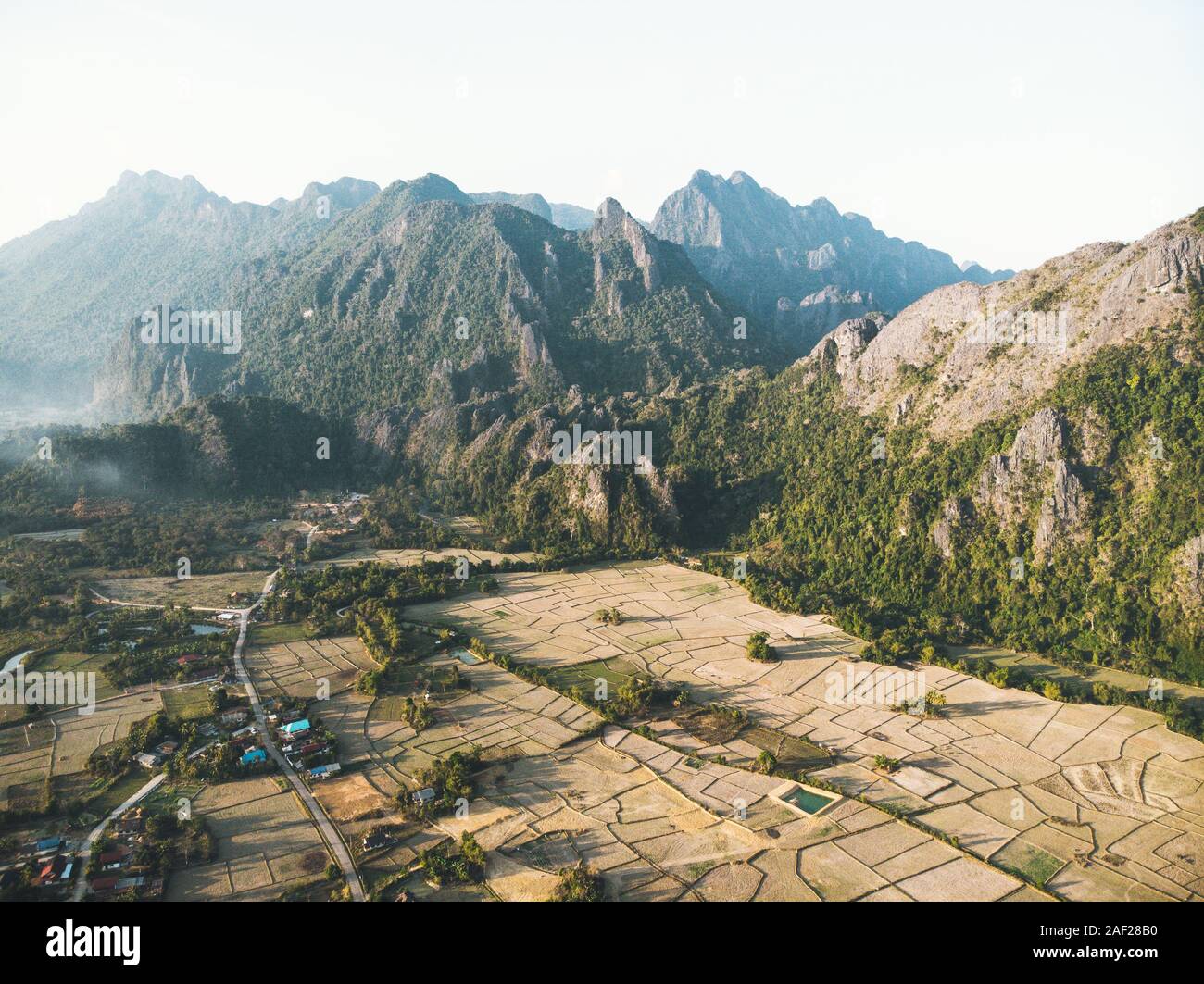 Aerial view of farm fields and rock formations in Vang Vieng, Laos ...