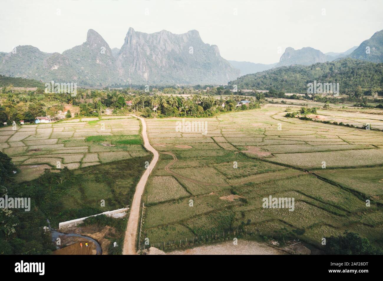 Aerial view of farm fields and rock formations in Vang Vieng, Laos ...
