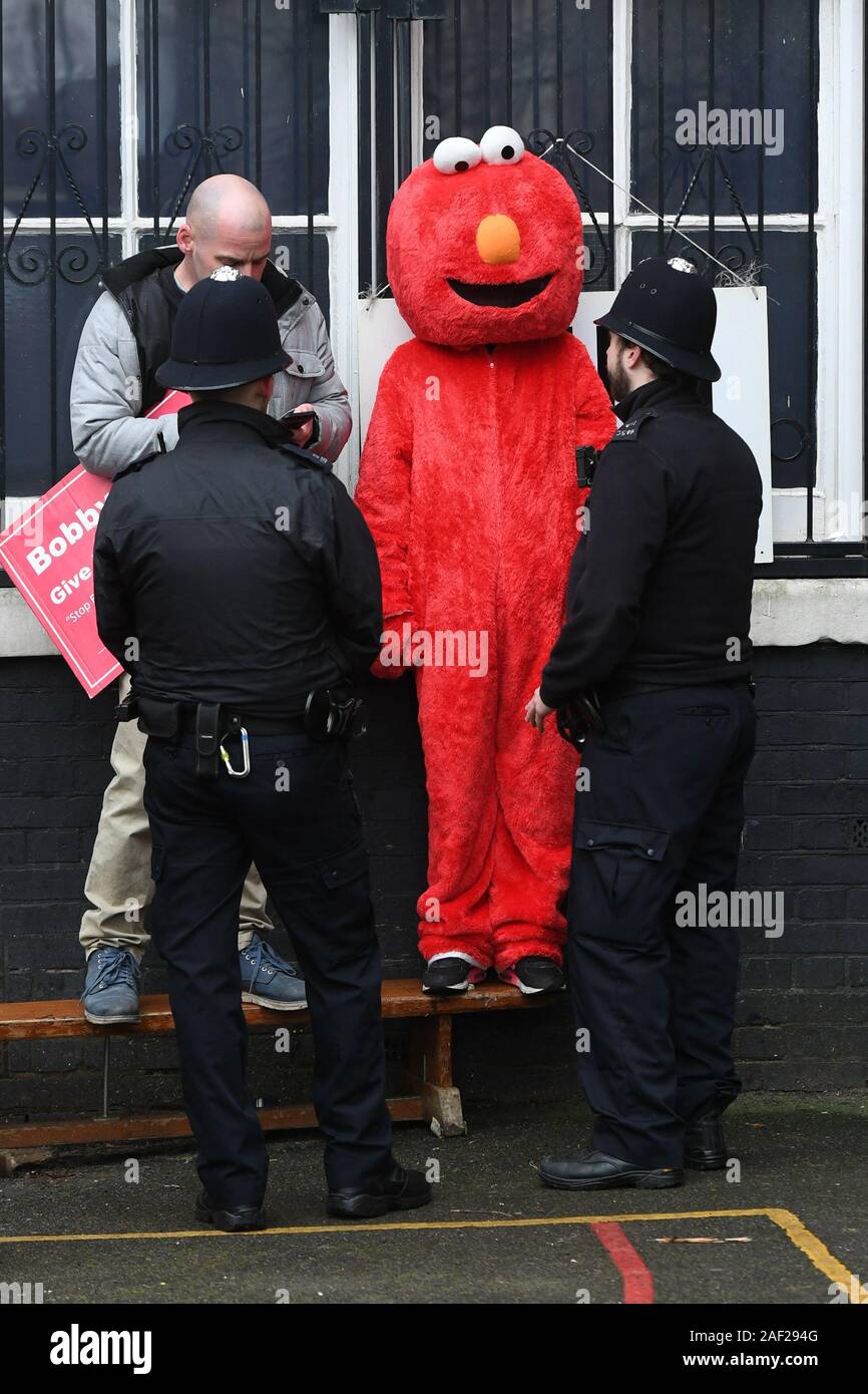 Police speak to a protester dressed as Elmo who attempted to approach ...