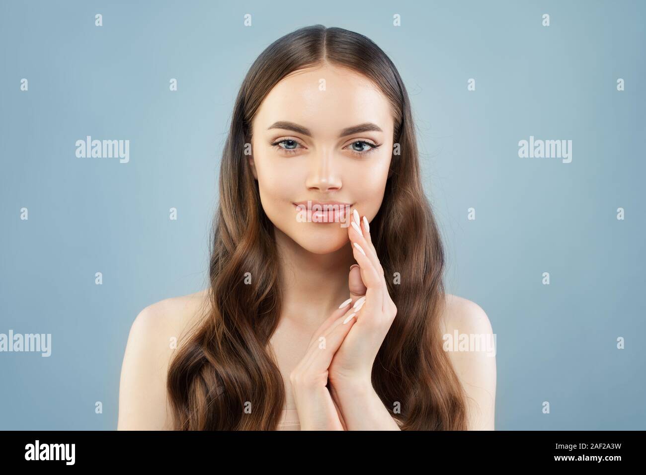 Lovely model woman with clear skin on blue background Stock Photo - Alamy
