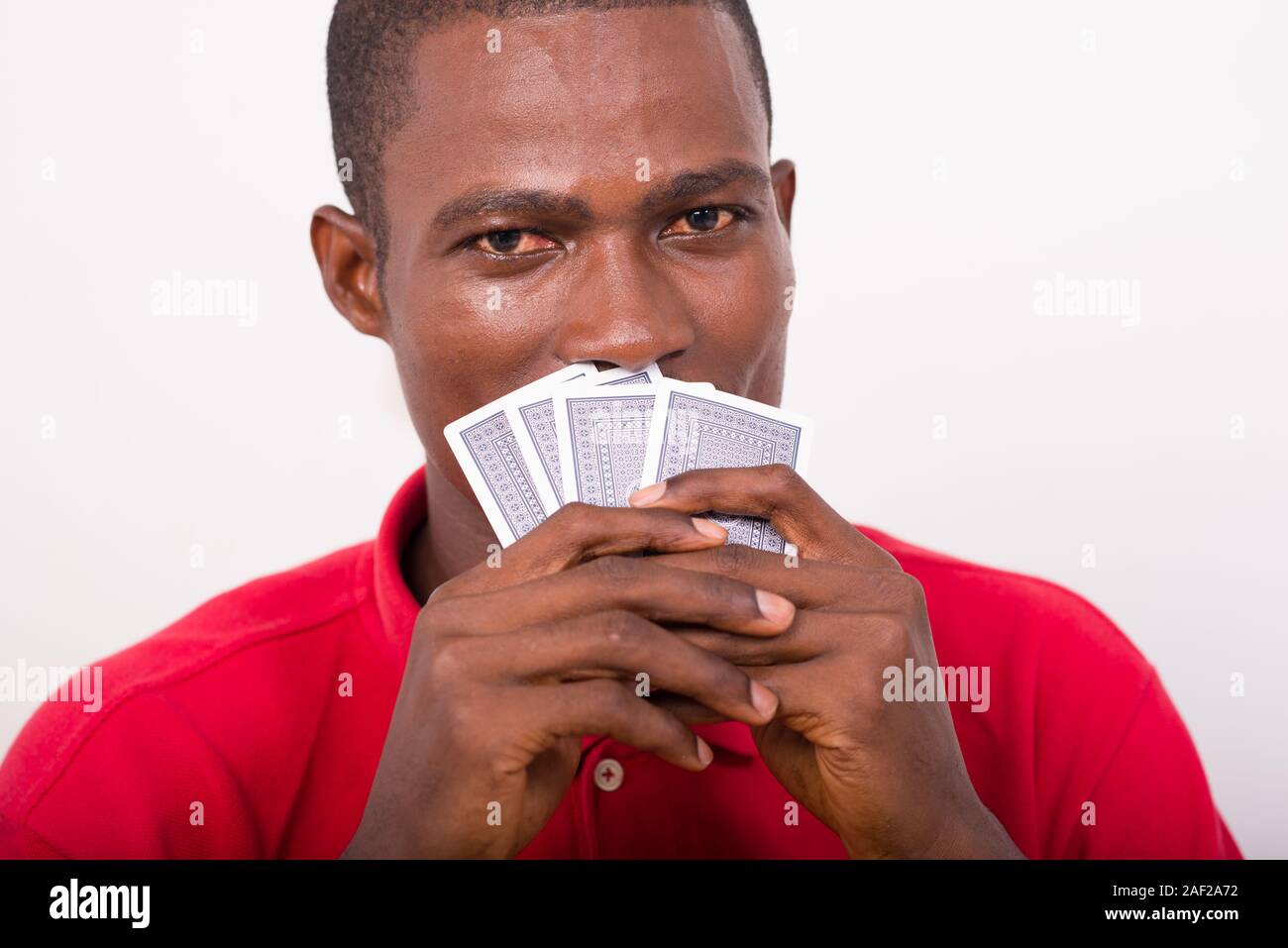 man holding playing cards sticking to face Stock Photo - Alamy
