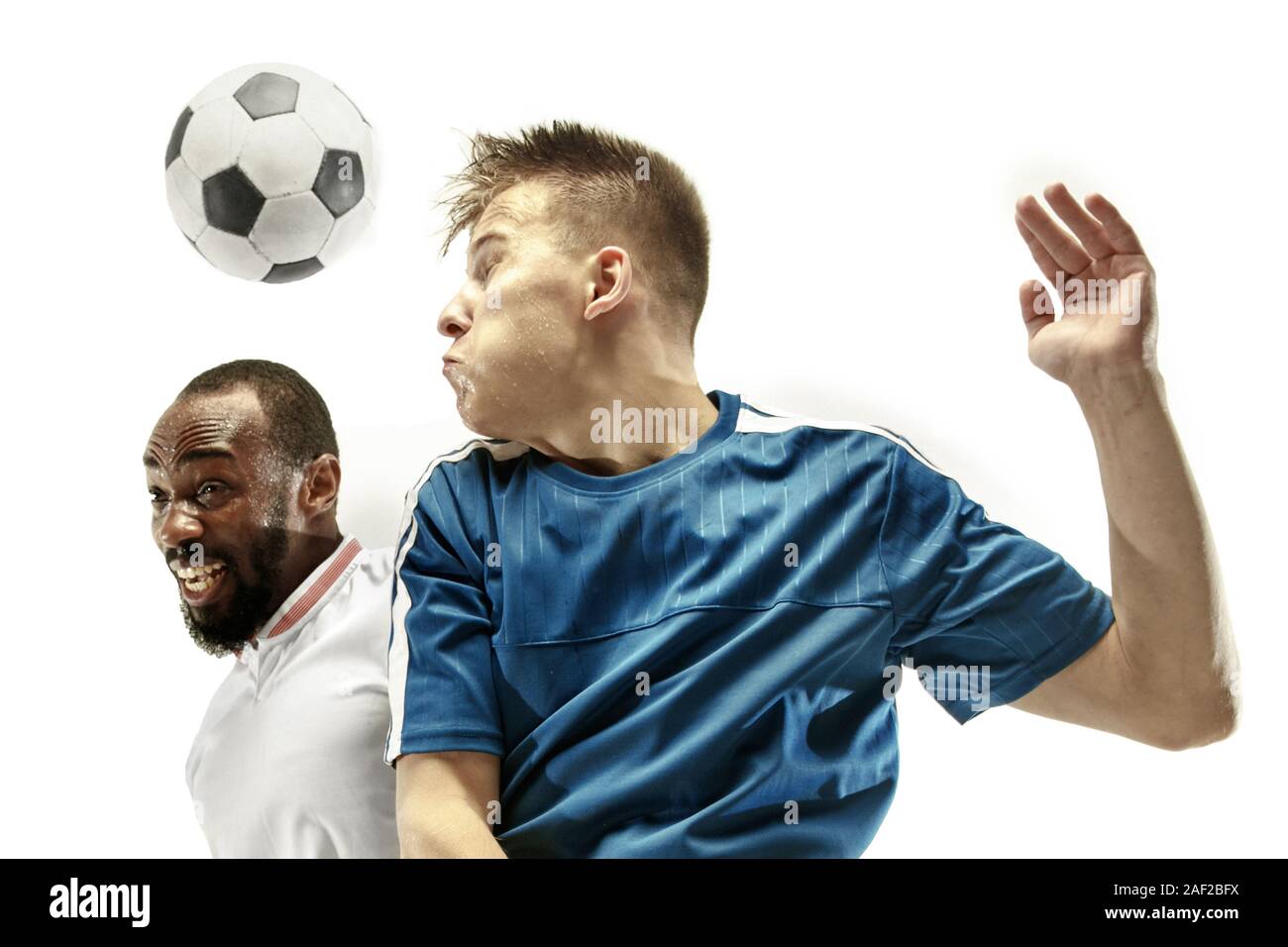 Close up of emotional men playing soccer hitting the ball with the head ...