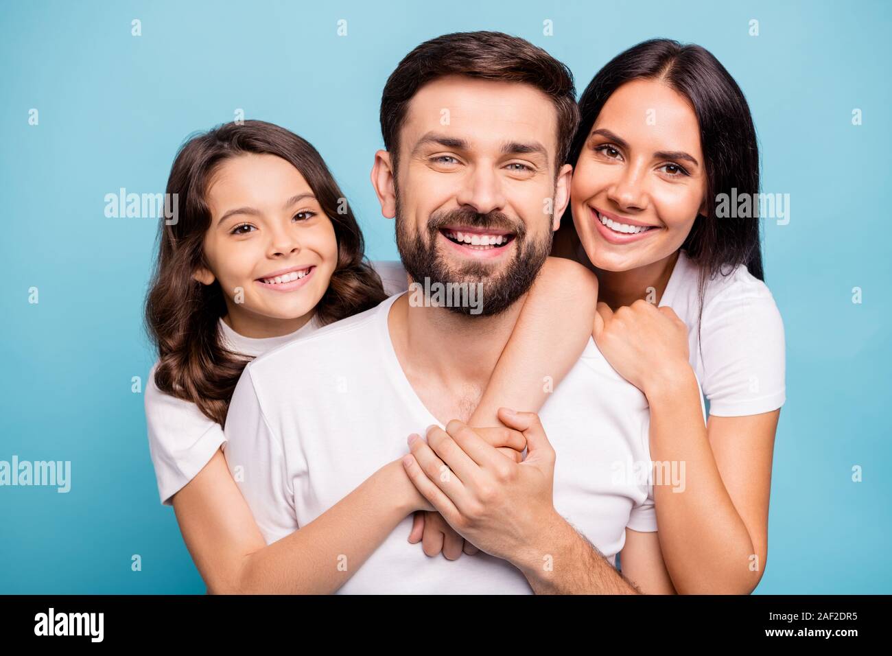 Close up photo of cheerful content three people with cute schoolkid hug ...
