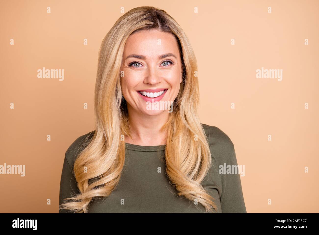 Portrait of cheerful cute nice pretty mature woman looking good smiling in green cheerfully ...