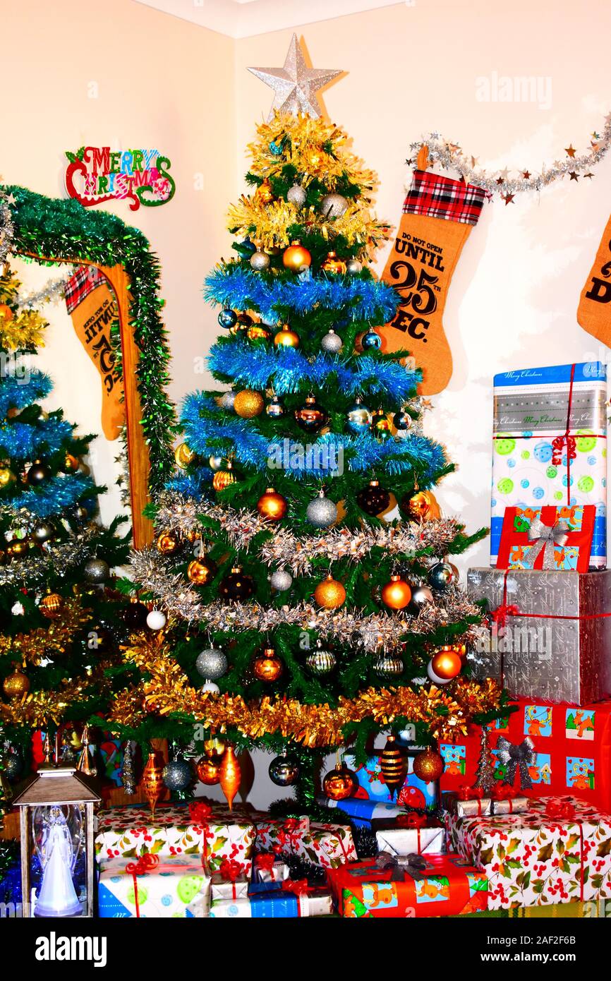 Christmas tree loaded with presents Stock Photo - Alamy