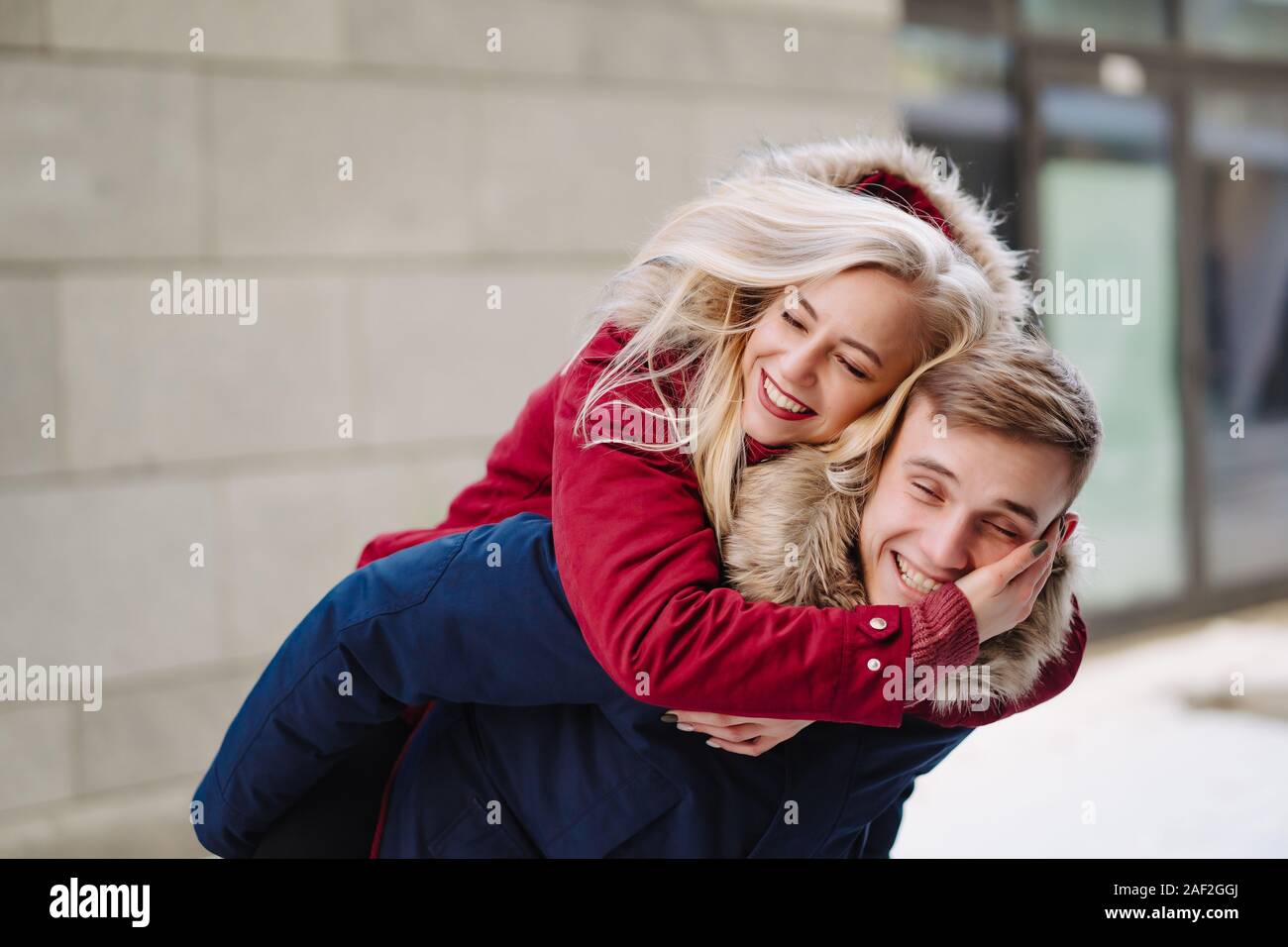 Young handsome guy giving girlfirend piggyback ride Stock Photo - Alamy