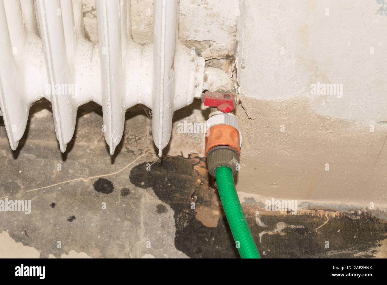 Drain water from a radiator to dismantle the radiator Stock Photo - Alamy