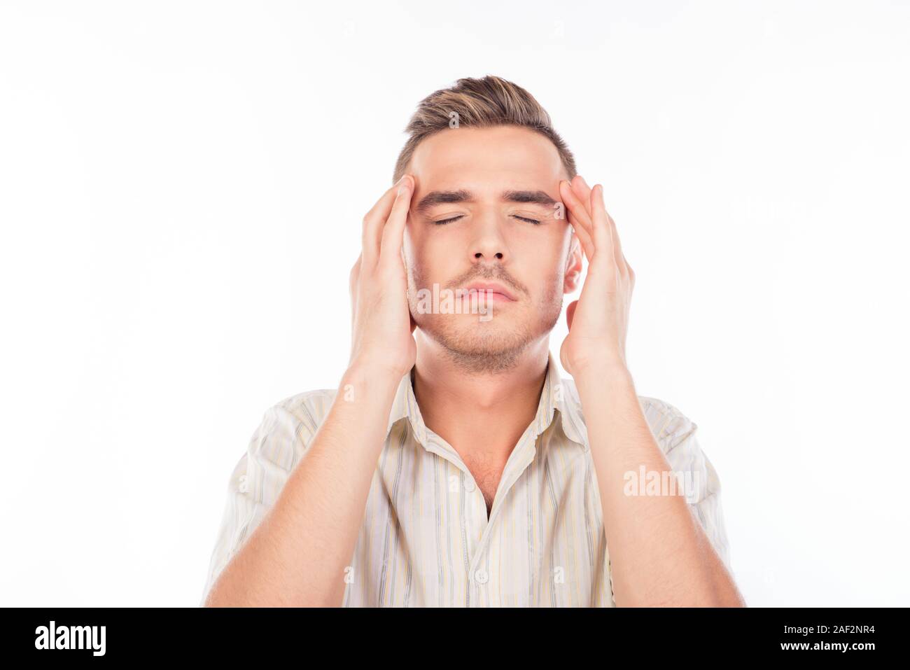 Handsome young man touching his head suffering from headache Stock ...