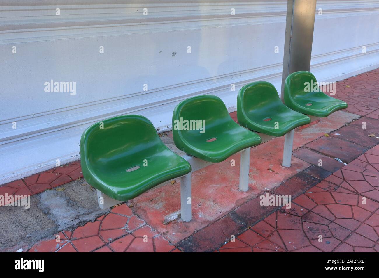 Closeup empty green plastic chairs at a bus stop, high angle view Stock ...
