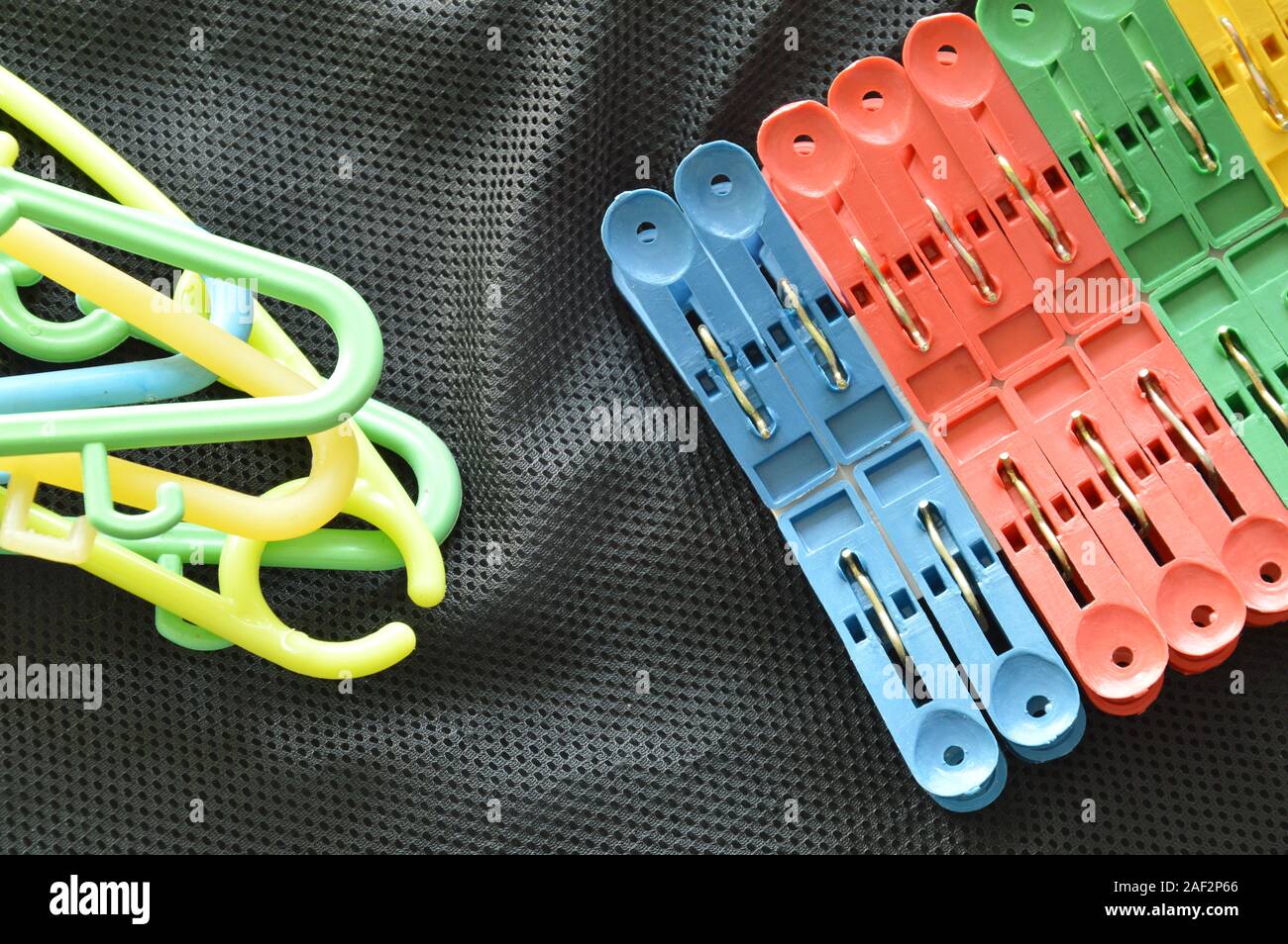 colorful plastic clothes peg and hunger on black fabric Stock Photo - Alamy